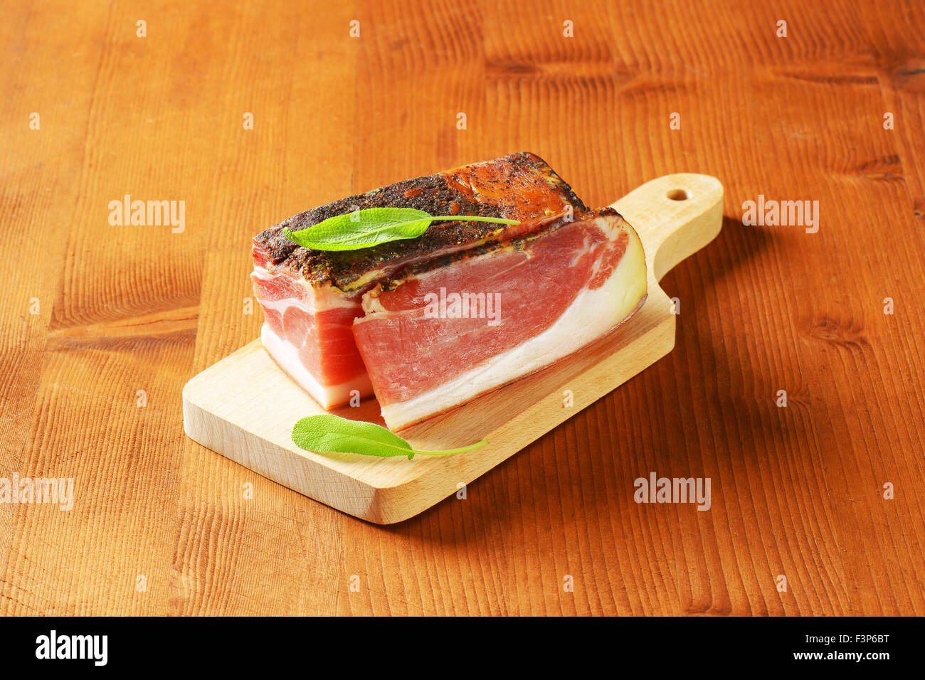 smoked bacon on wooden cutting board Stock Photo - Alamy
