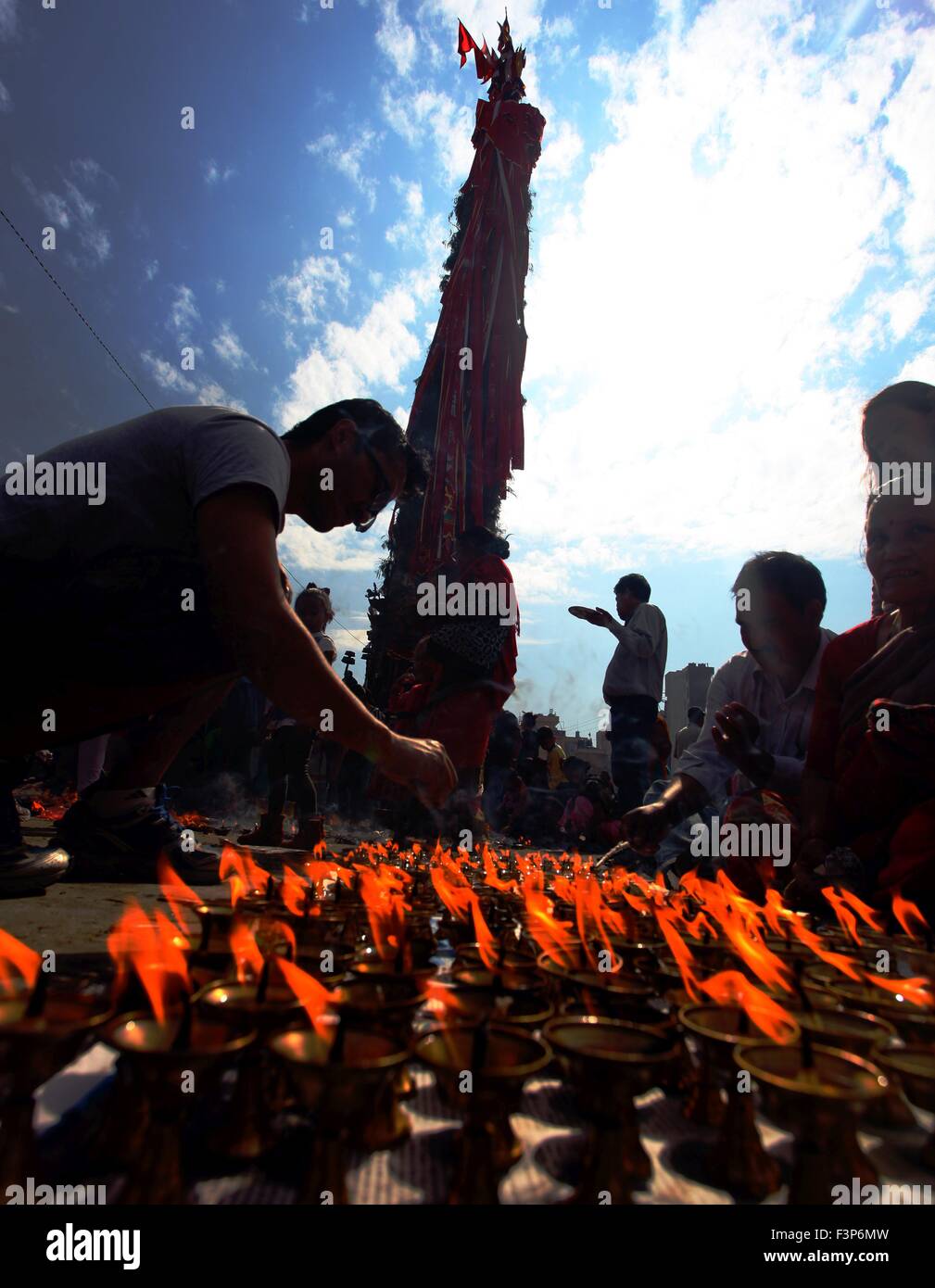 Lalitpur, Nepal. 10th Oct, 2015. Devotees light butter lamps to offer ...