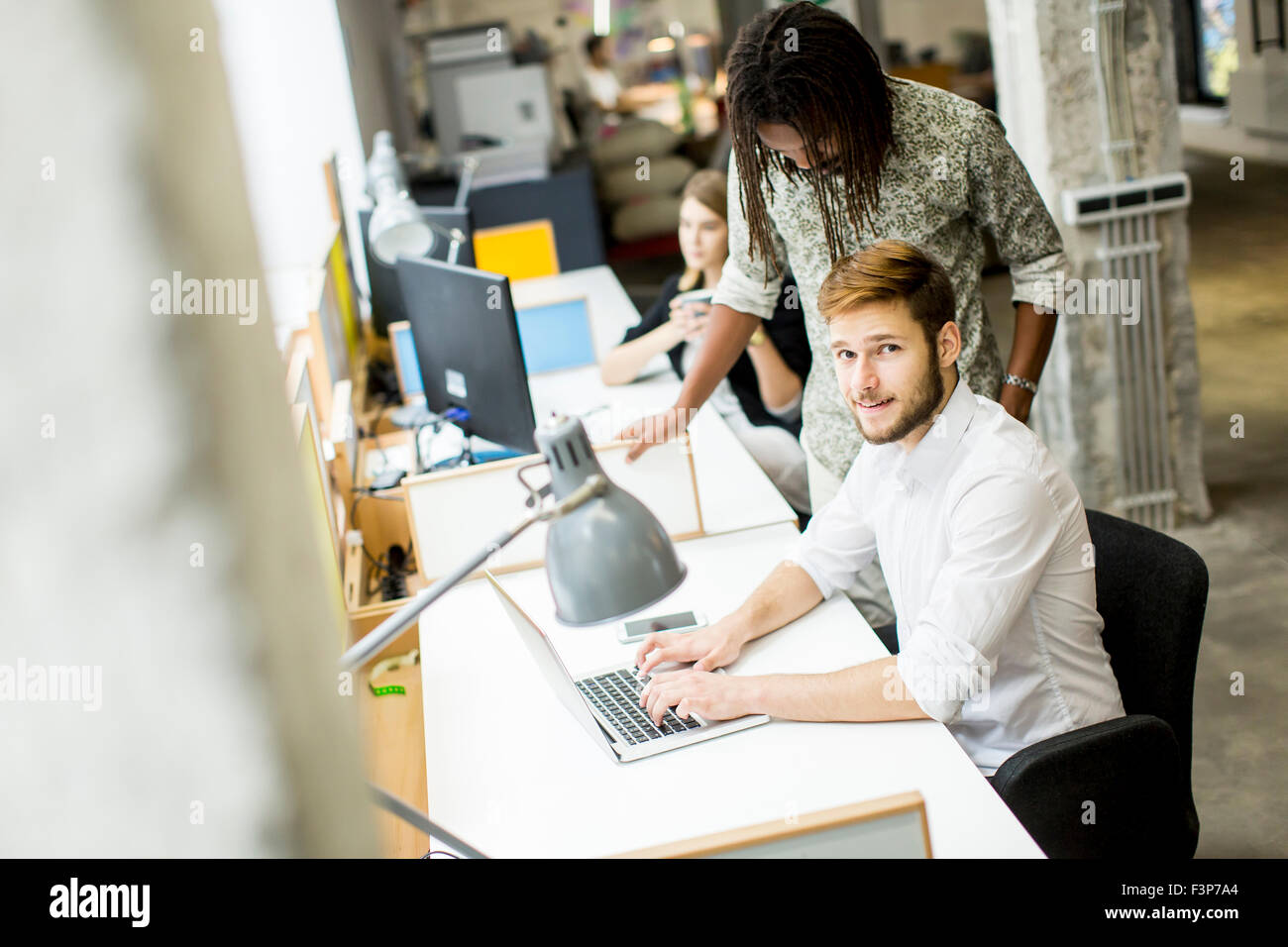 Young people in the office Stock Photo - Alamy