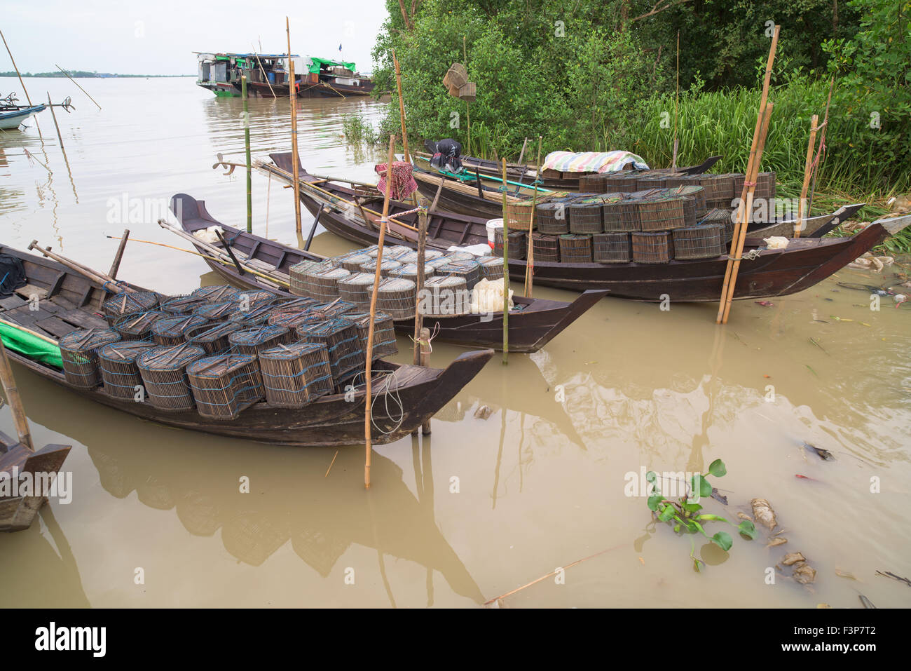 Traditional, wooden boats loaded with fishing gear on the Ywe River in ...