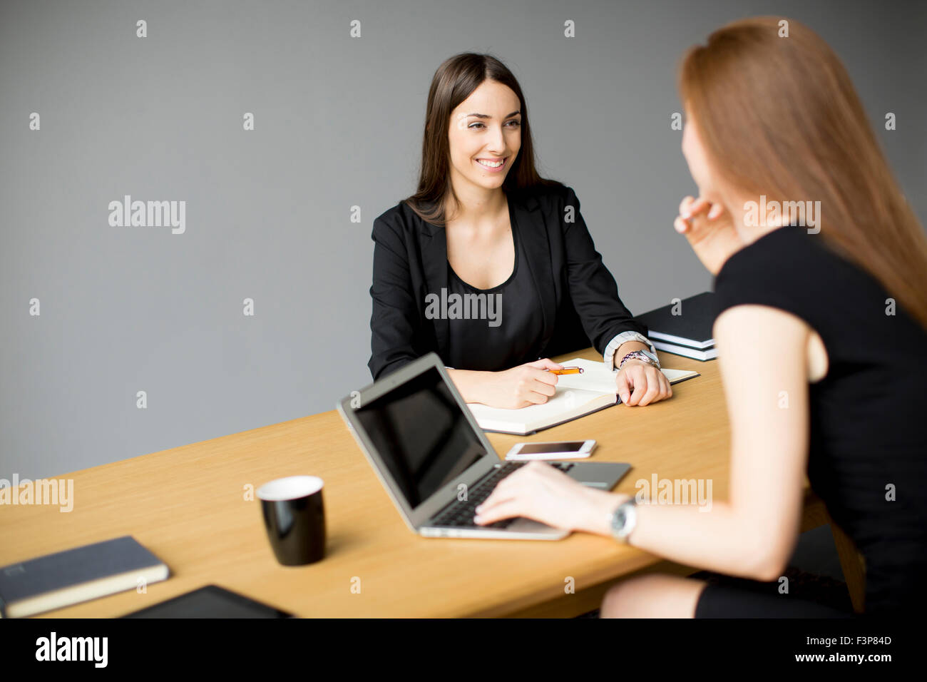Young women working in the office Stock Photo - Alamy