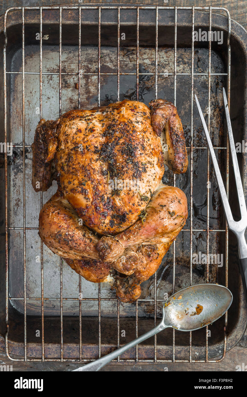 Roast chicken on rustic wooden table - top view Stock Photo - Alamy