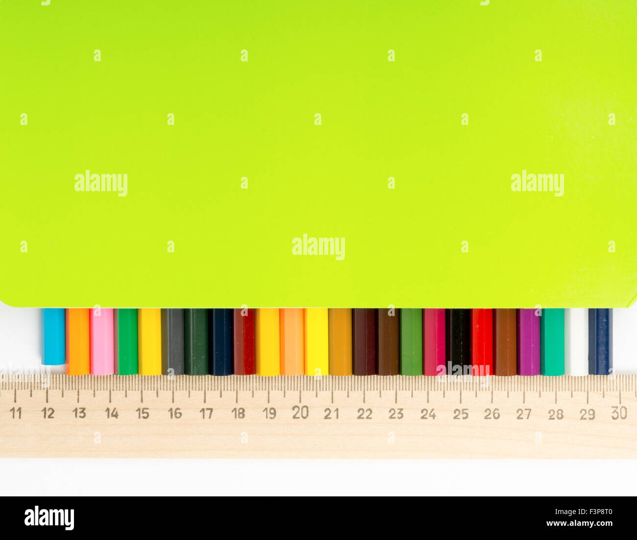 Crayons with ruler and copybook, close up view Stock Photo - Alamy