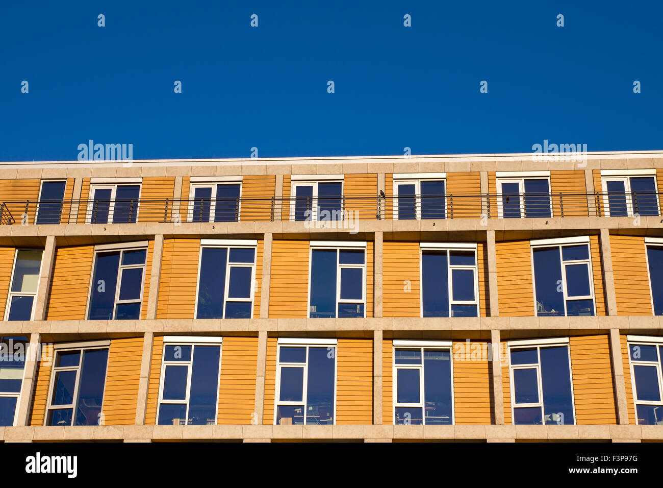 A facade of a modern orange office building Stock Photo - Alamy