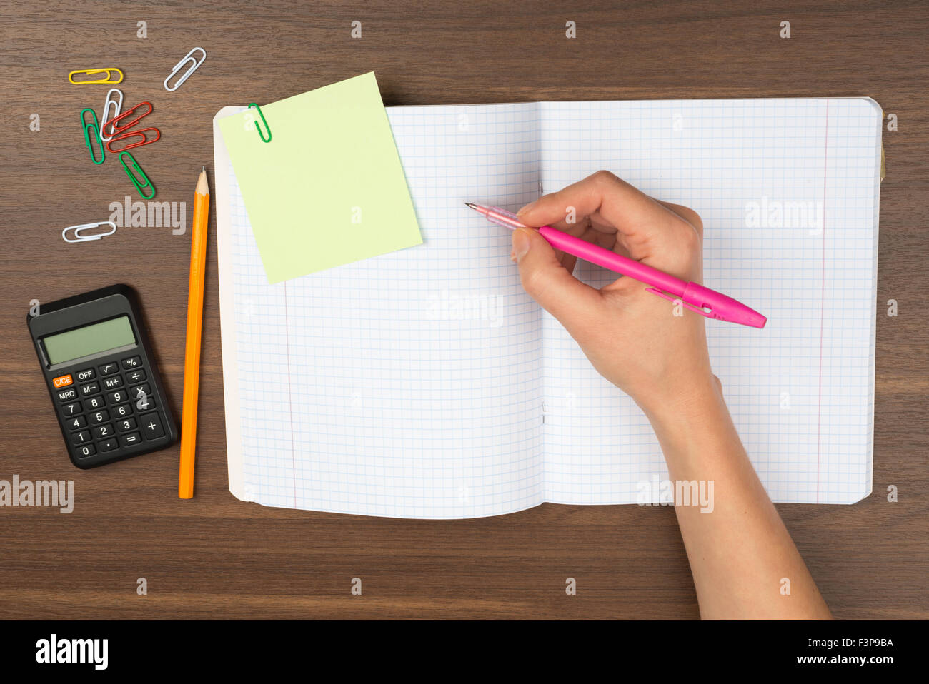 Humans writing hand on table with pencil Stock Photo - Alamy