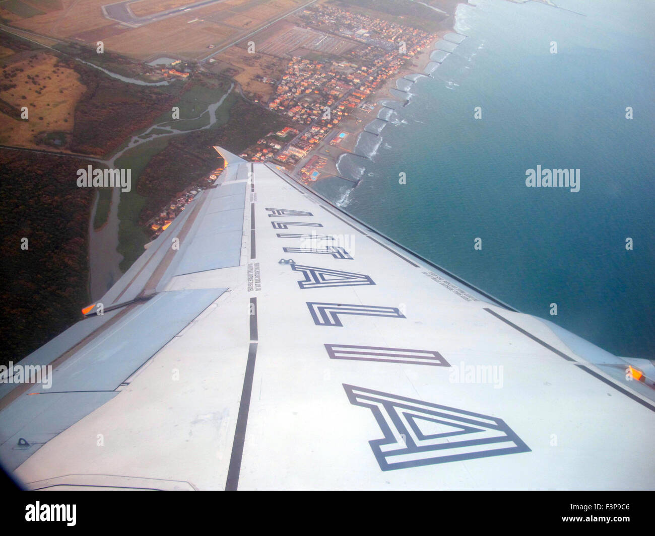 Alitalia passenger jet wing and logo during flight Stock Photo - Alamy