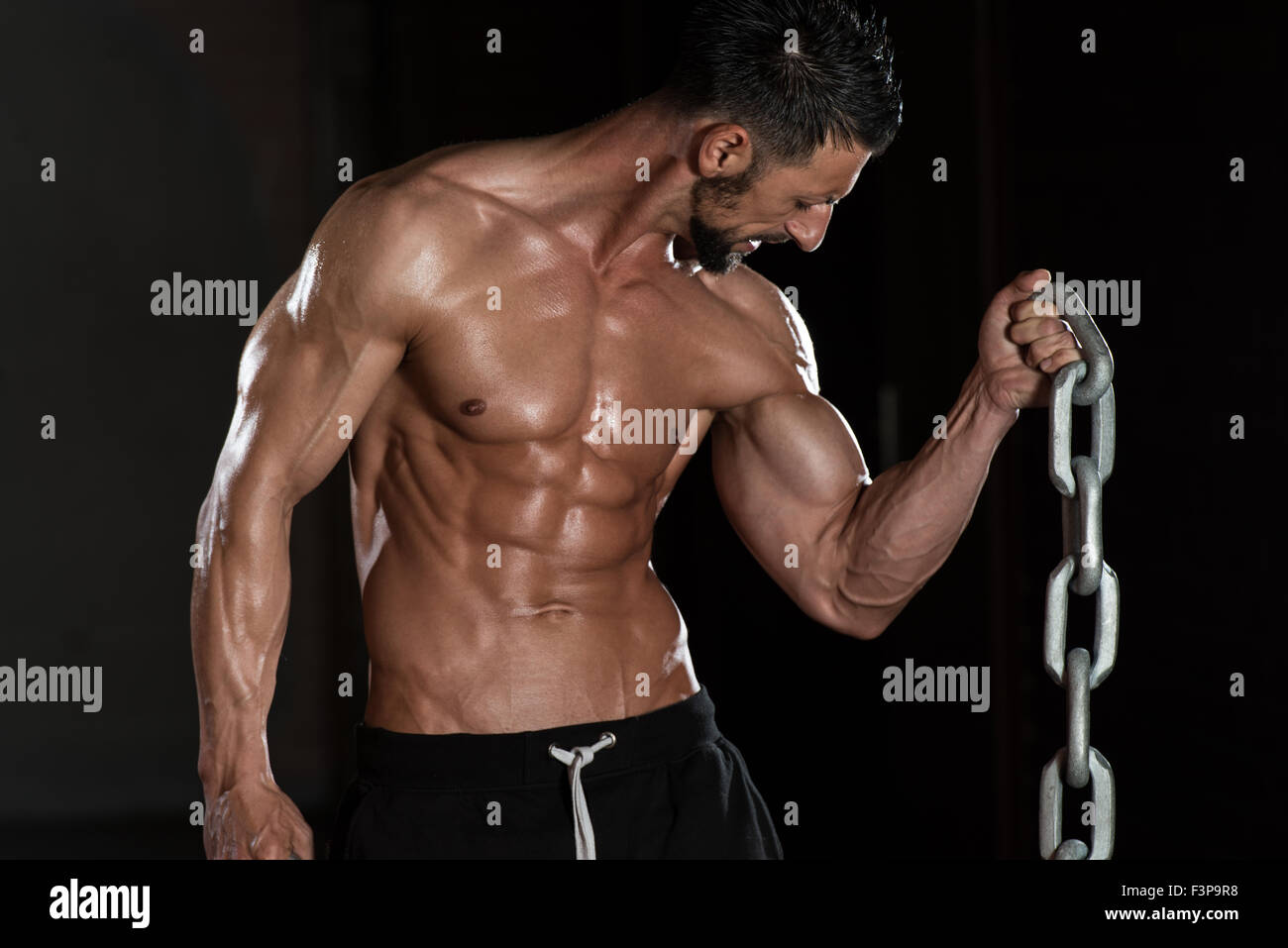 Healthy Bodybuilder Exercising Biceps With Chains Stock Photo - Alamy