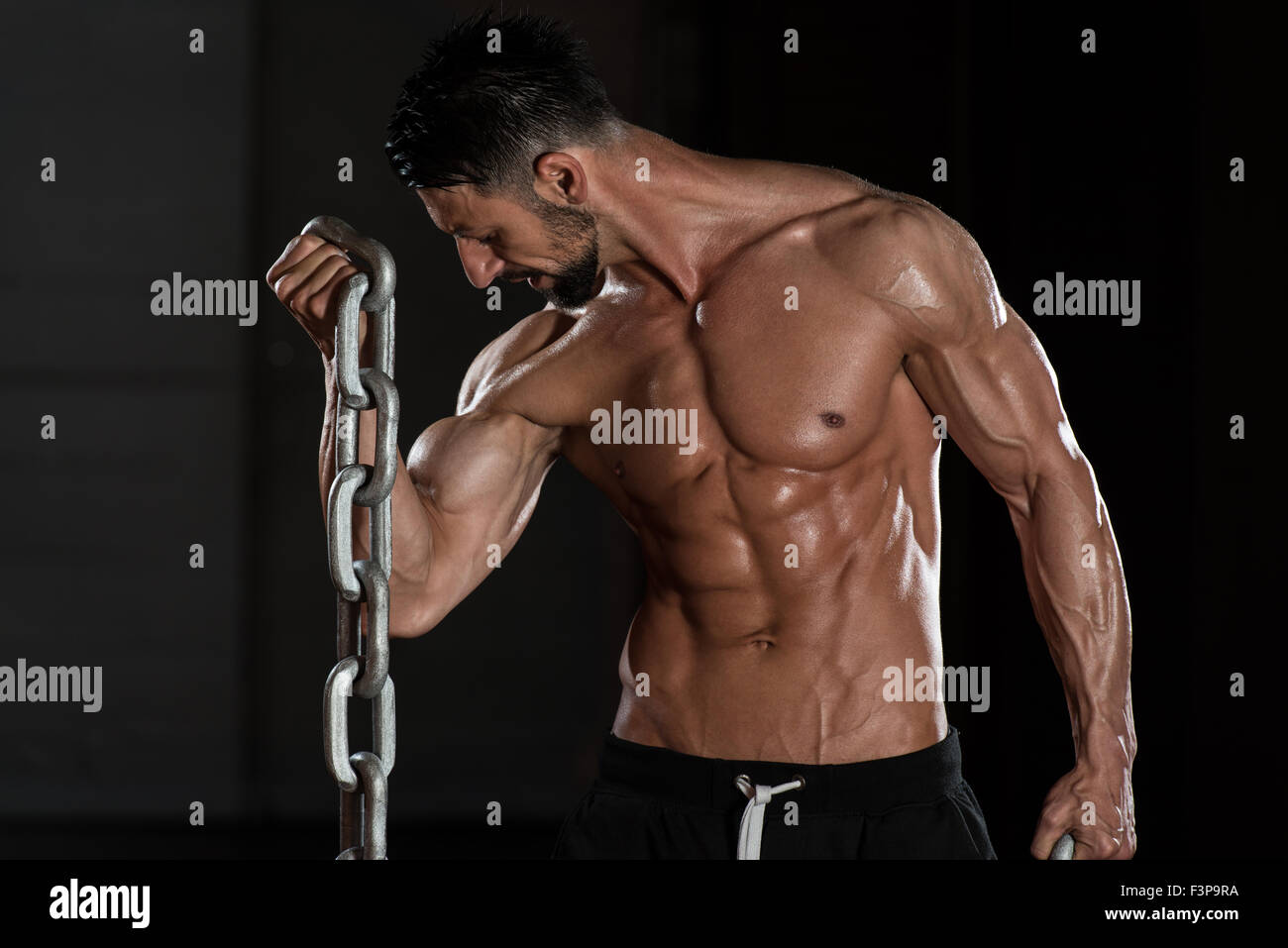 Healthy Bodybuilder Exercising Biceps With Chains Stock Photo - Alamy