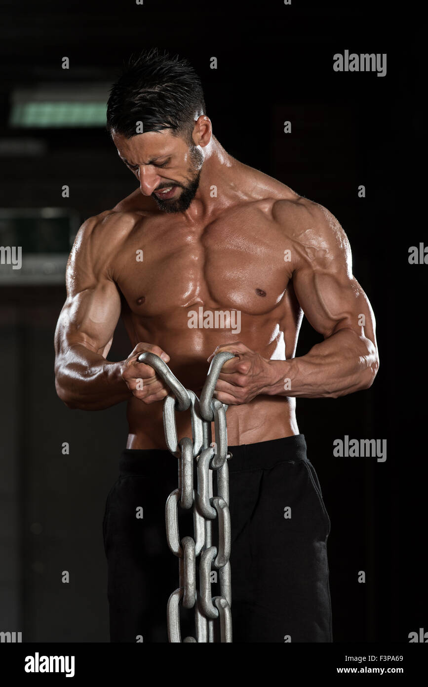 Healthy Bodybuilder Exercising Biceps With Chains Stock Photo - Alamy