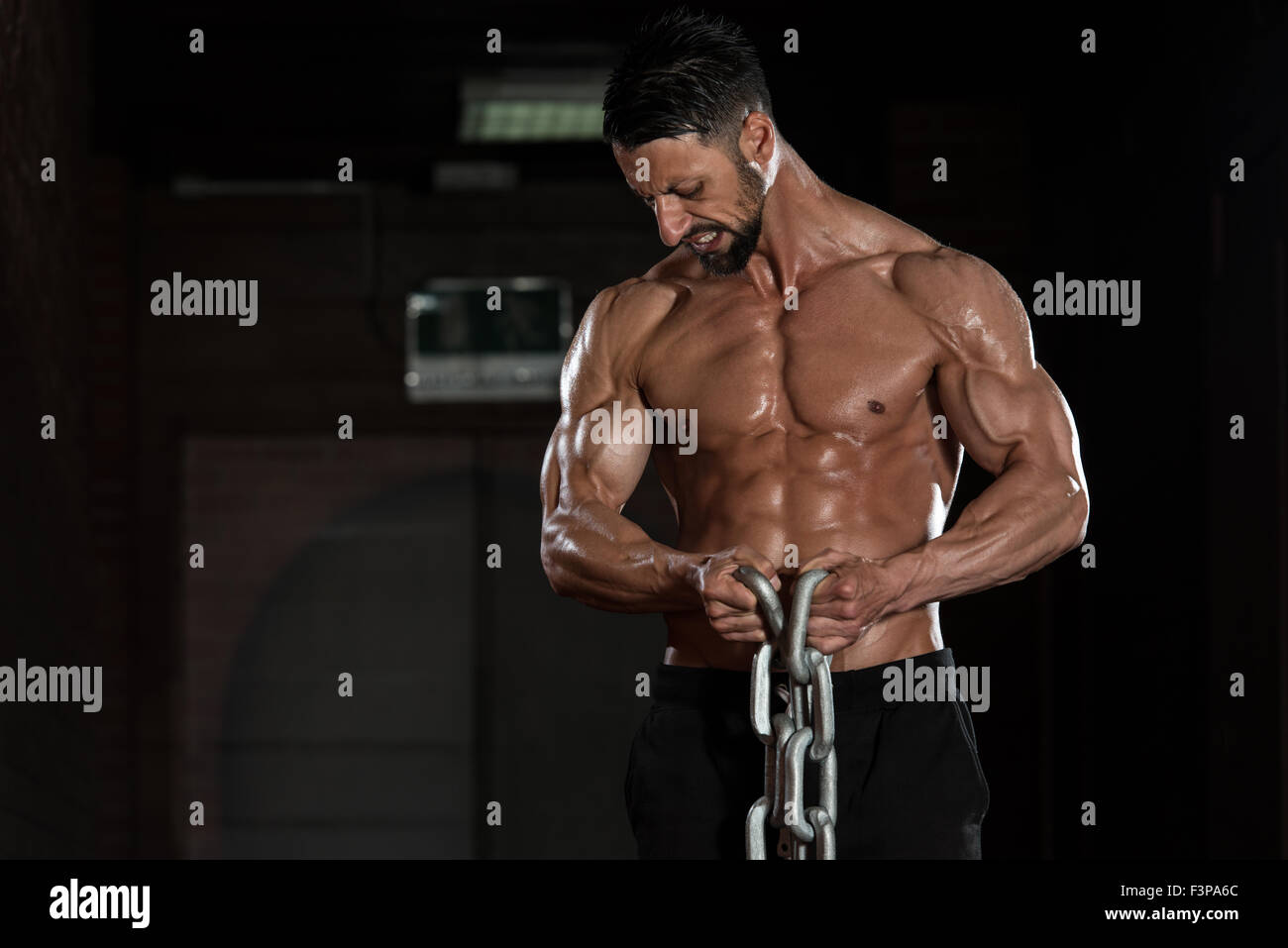 Healthy Bodybuilder Exercising Biceps With Chains Stock Photo - Alamy