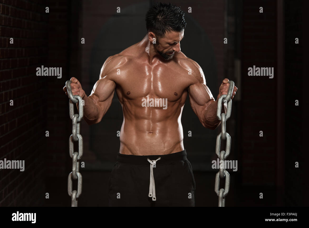 Healthy Bodybuilder Exercising Biceps With Chains Stock Photo - Alamy
