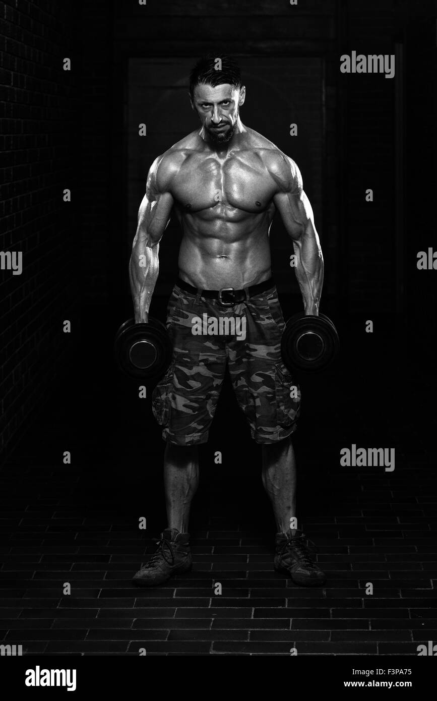 Healthy Man Working Out Biceps - Dumbbell Concentration Curls Stock ...
