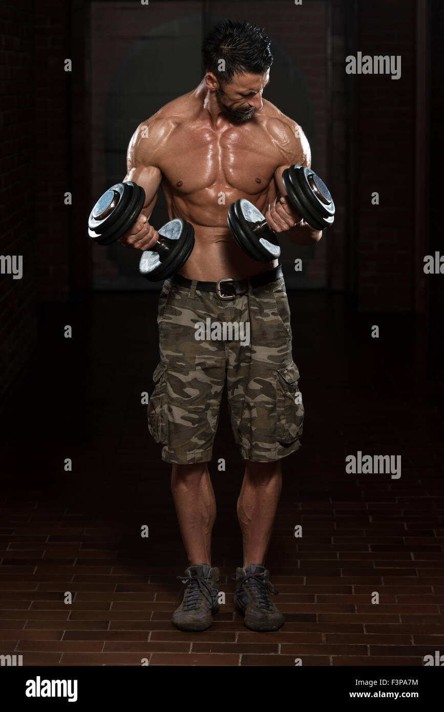 Healthy Man Working Out Biceps - Dumbbell Concentration Curls Stock ...