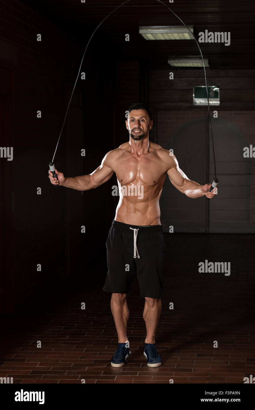 Handsome Muscular Man Exercising Jumping Rope - Cardio Time Stock Photo ...