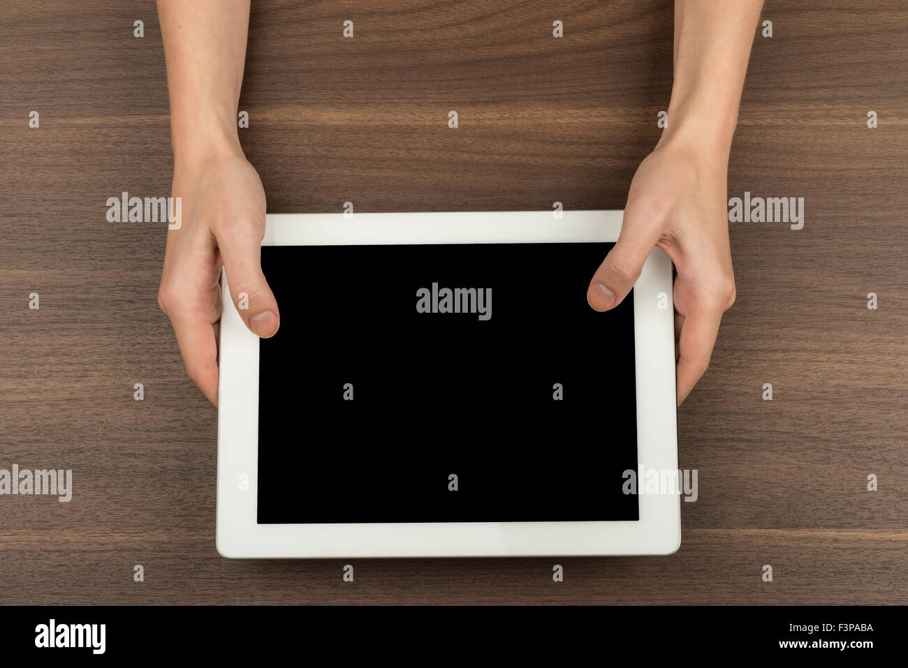 Humans hands holding tablet Stock Photo - Alamy