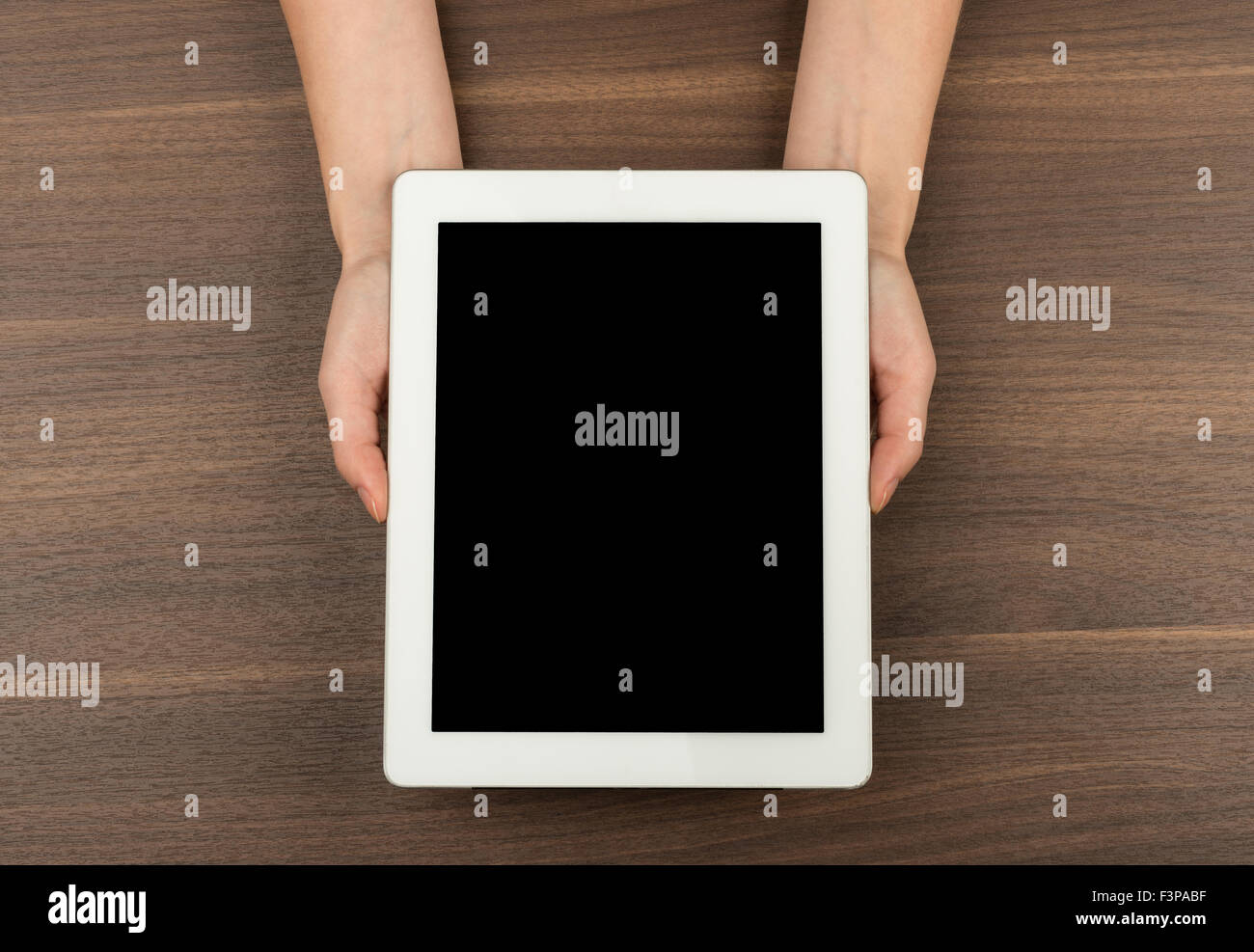 Humans hands holding tablet, top view Stock Photo - Alamy