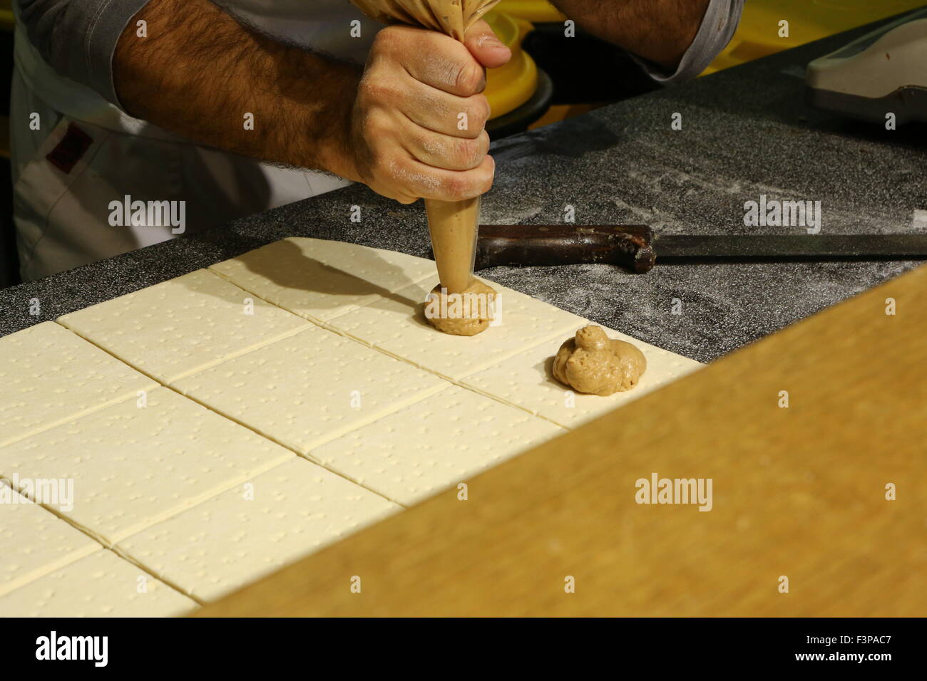Baker working in a bakery Stock Photo - Alamy