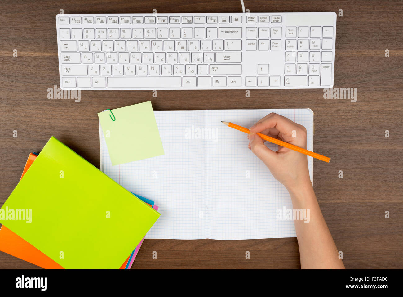 Humans hand writing in copy book Stock Photo - Alamy