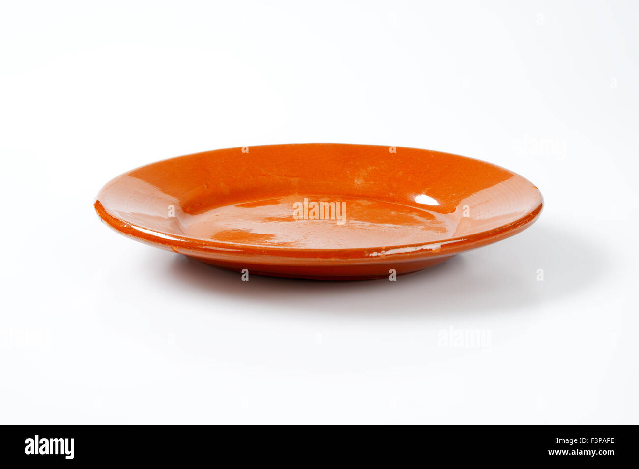empty orange plate on white background Stock Photo - Alamy