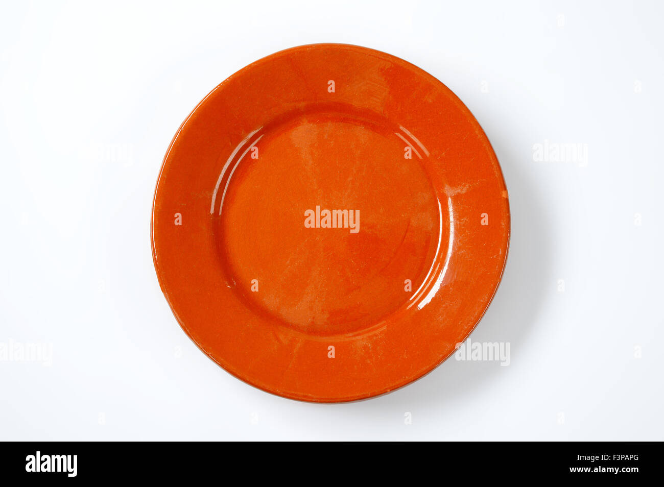 empty orange plate on white background Stock Photo - Alamy