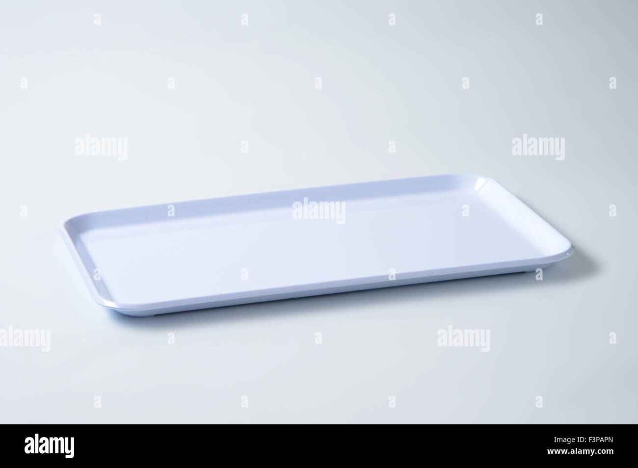 empty white tray on white background Stock Photo - Alamy