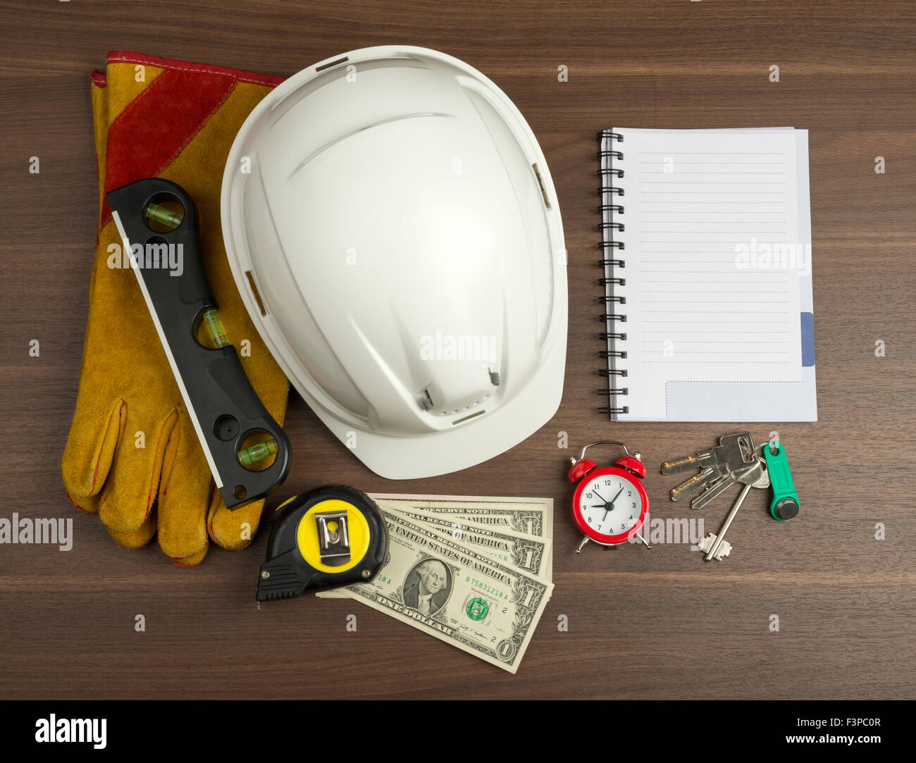Construction gloves with builders level Stock Photo - Alamy