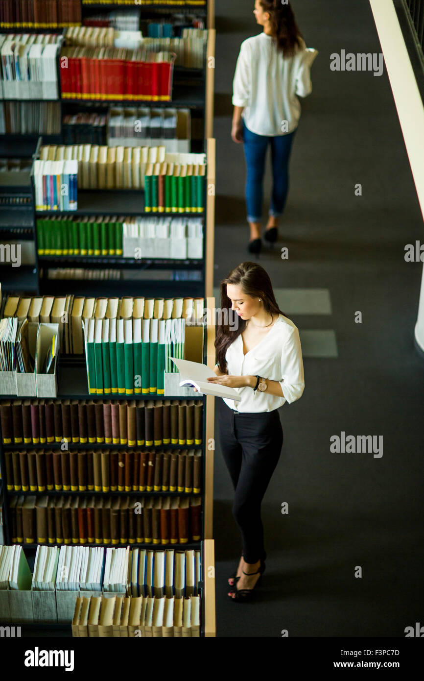 Young women in the library Stock Photo - Alamy