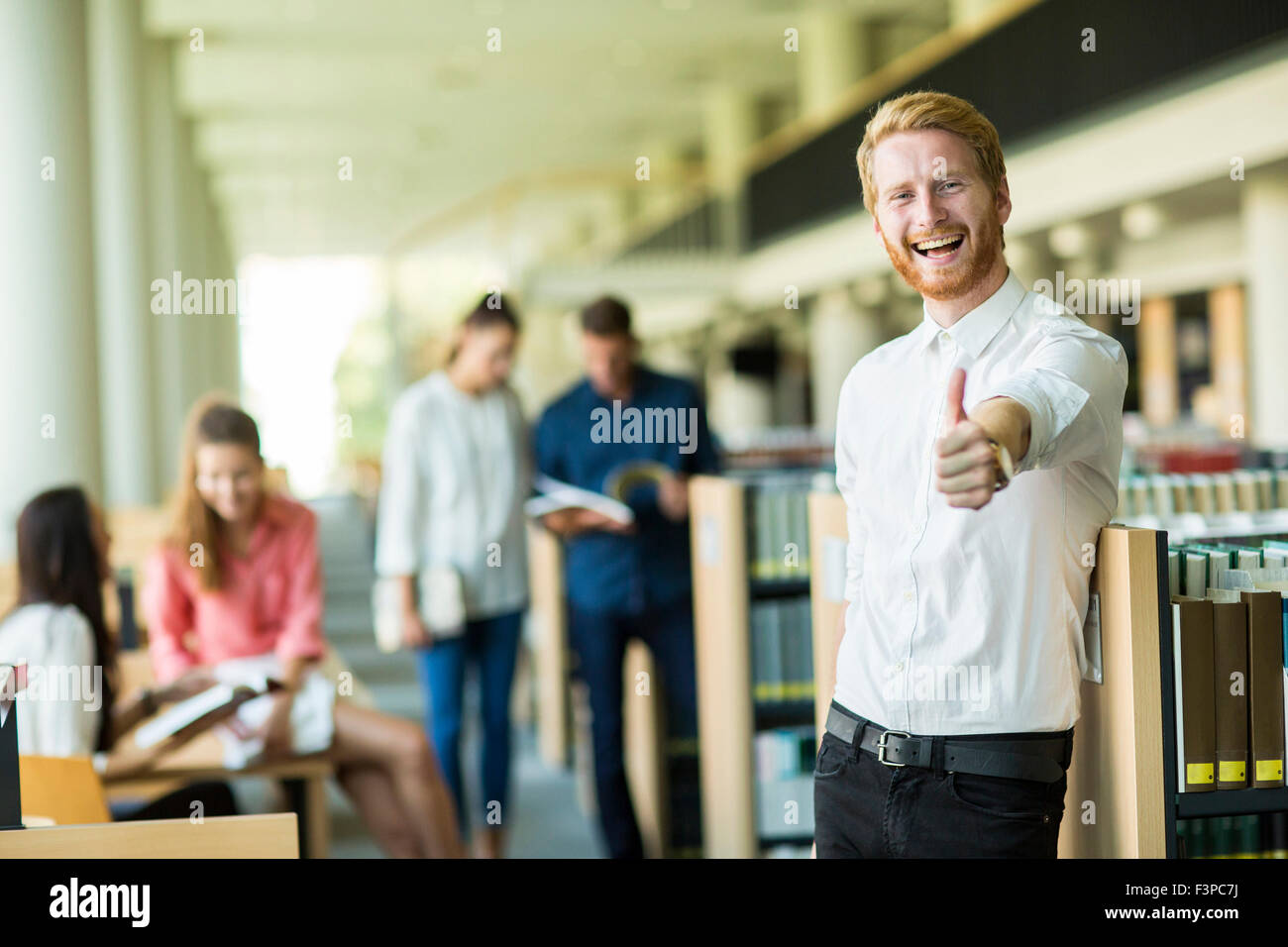Young man in the library Stock Photo - Alamy