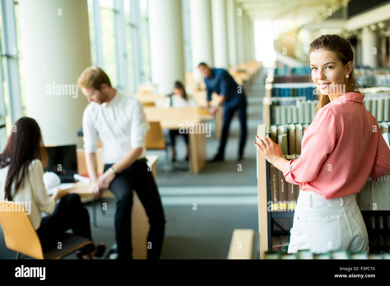 Young woman in the library Stock Photo - Alamy
