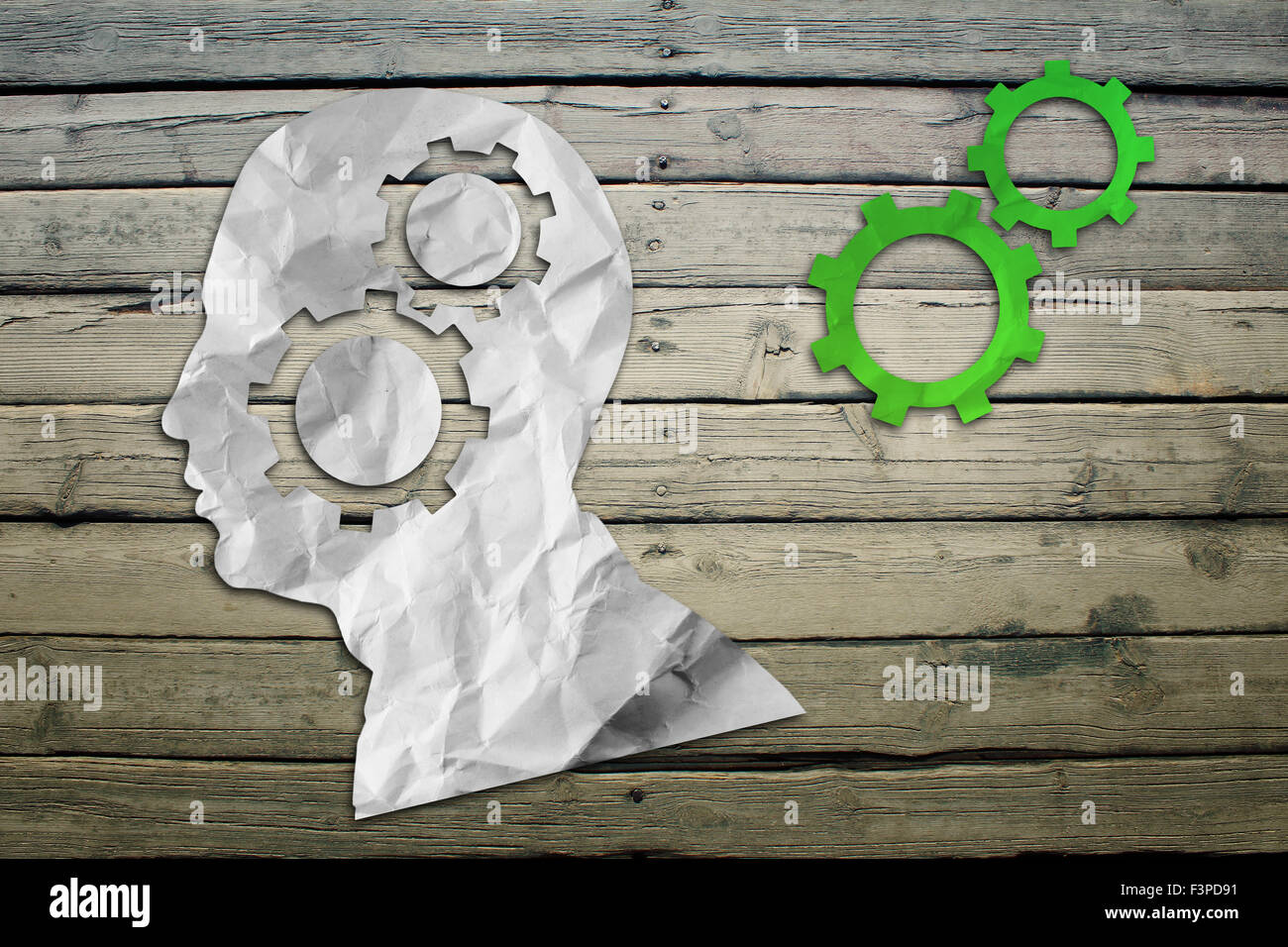 Paper humans head with wheel symbols Stock Photo - Alamy