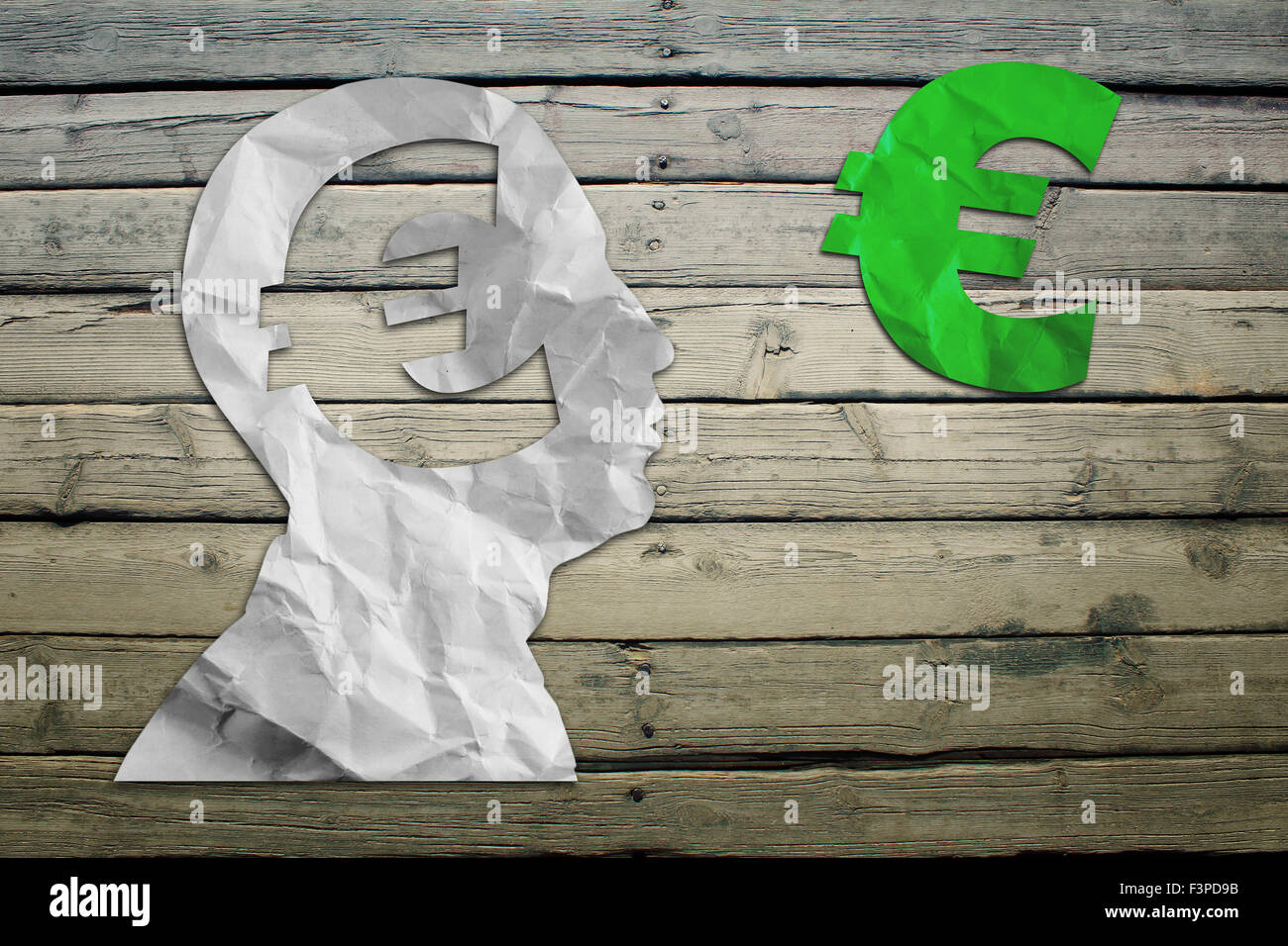 Paper humans head with euro symbol Stock Photo - Alamy