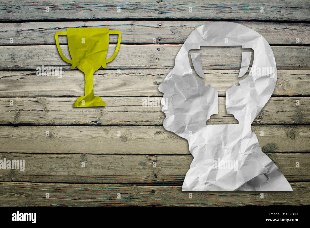 Paper humans head with winner cup symbol Stock Photo - Alamy