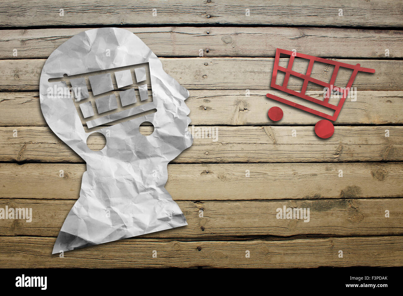 Paper humans head with shopping cart symbol Stock Photo - Alamy