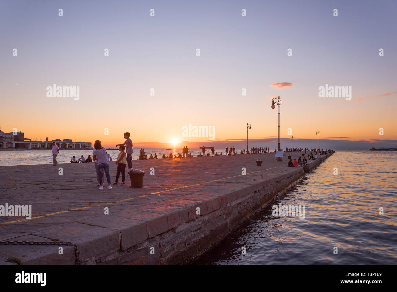 Trieste Italy harbor harbour waterfront, view at sunset of people ...