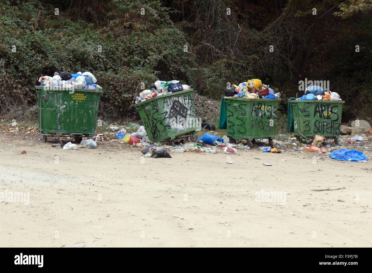 Overflowing garbage cans Stock Photo - Alamy