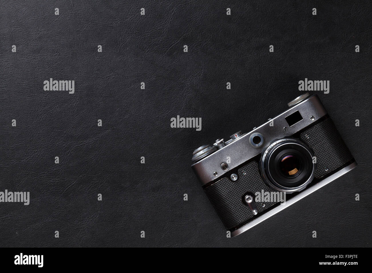 Vintage film camera over leather desk table. Top view with copy space ...