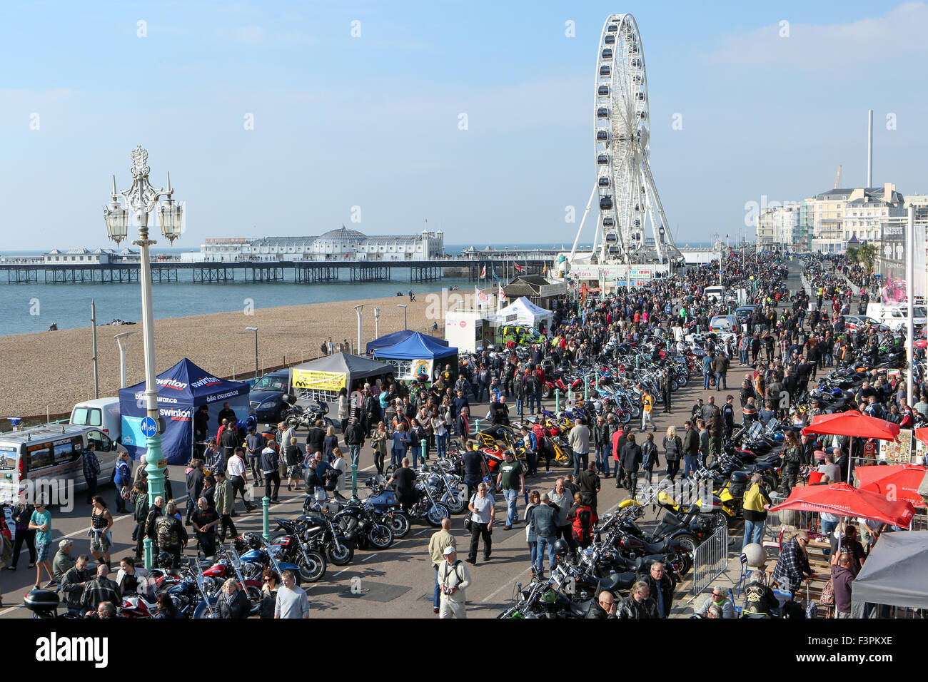 Crowds wander around Madeira Drive, Brighton, East Sussex, UK attending ...