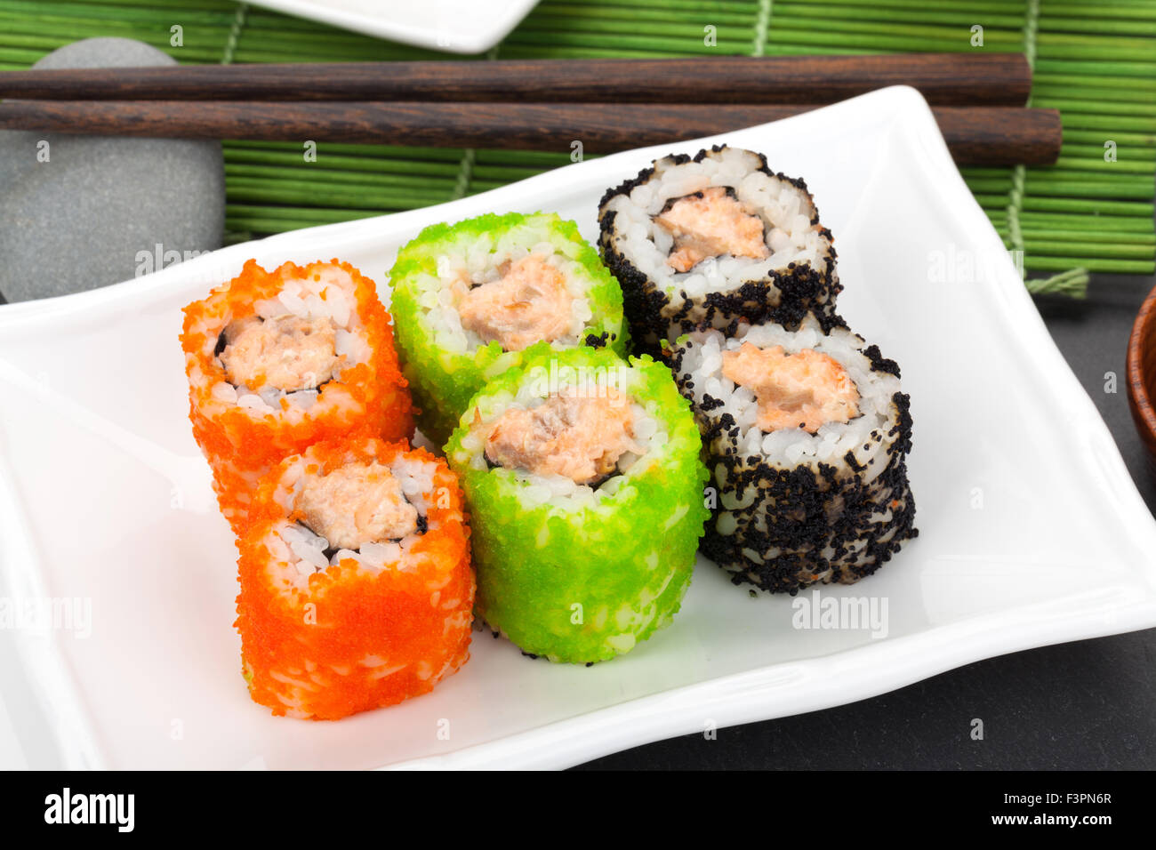 Colorful sushi maki with tobiko on bamboo mat Stock Photo - Alamy