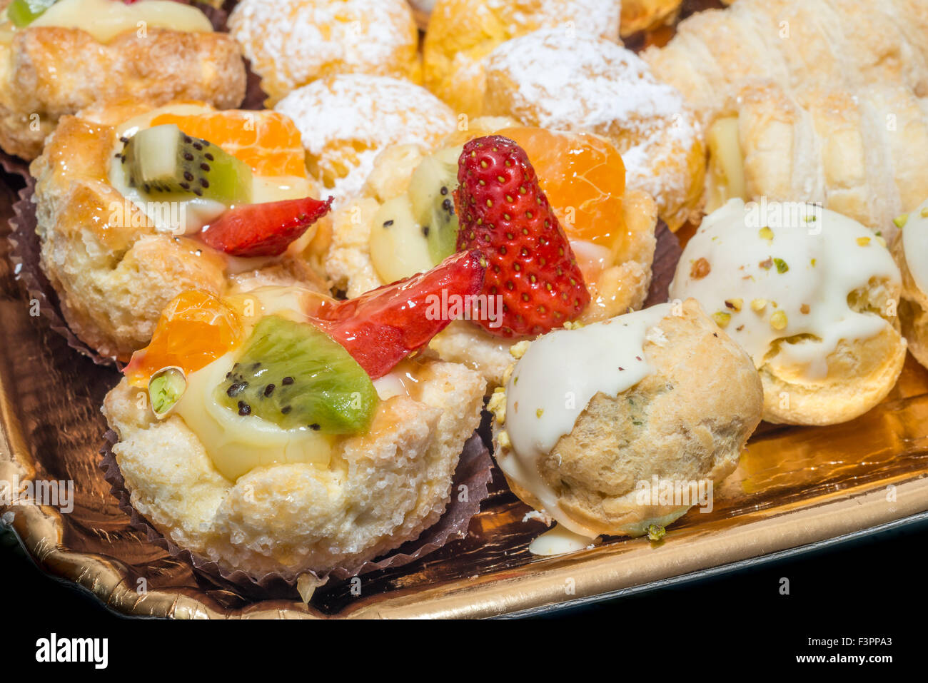 colorful pastries with fruits, cream and chocolate, the real Italian ...