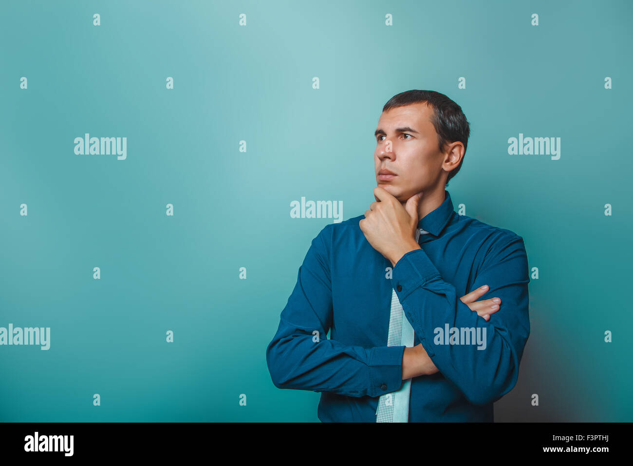 a man of European appearance thirty years thinking hand on chin Stock ...