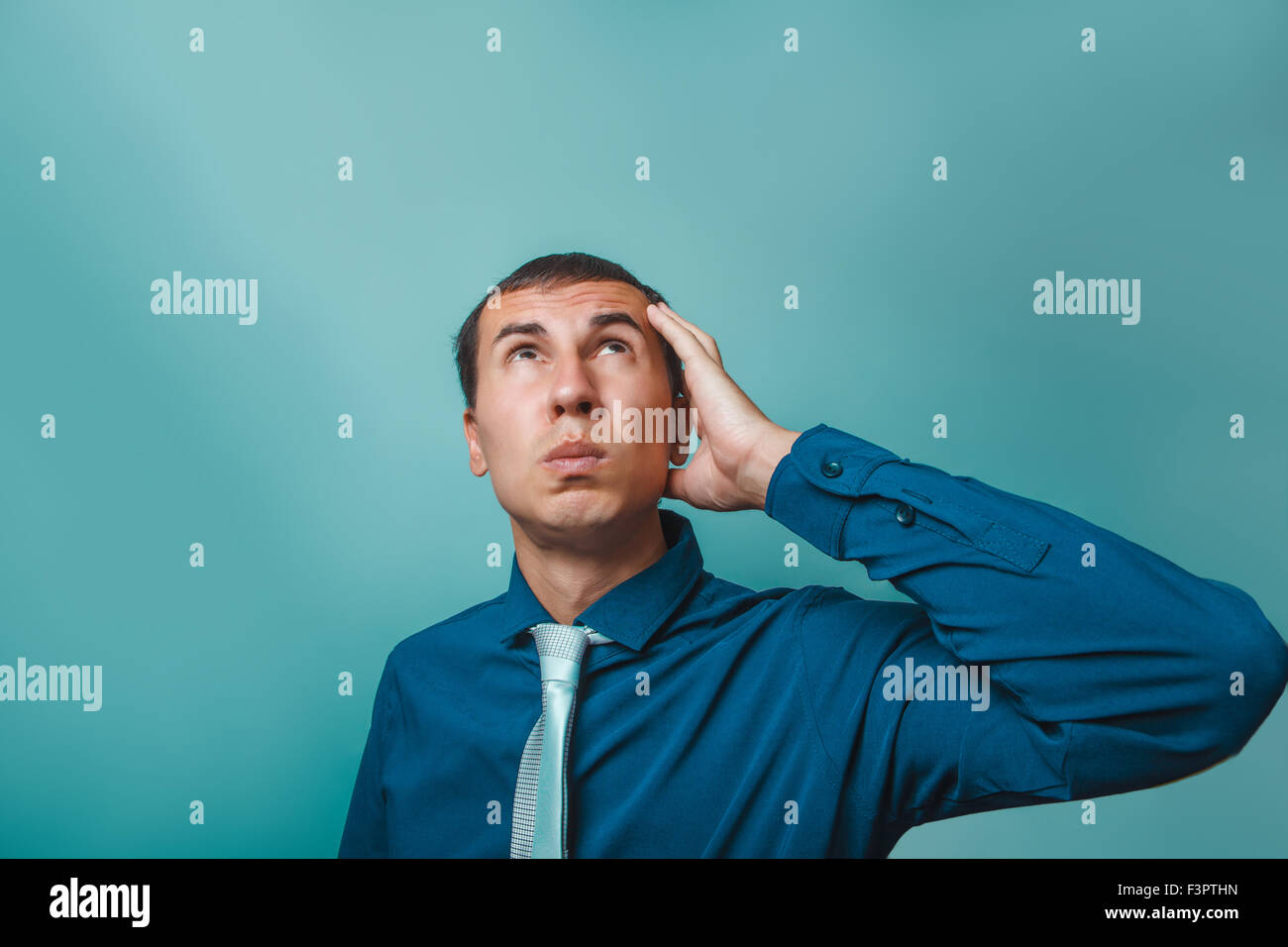 a man of European appearance thirty years thinking hand on chin Stock ...