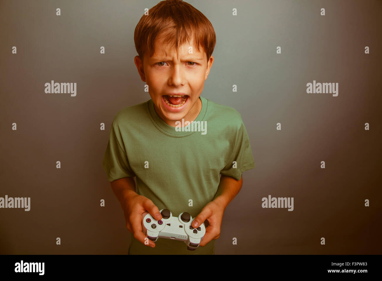 Teen boy screaming open mouth holds emotions game joystick on a Stock ...