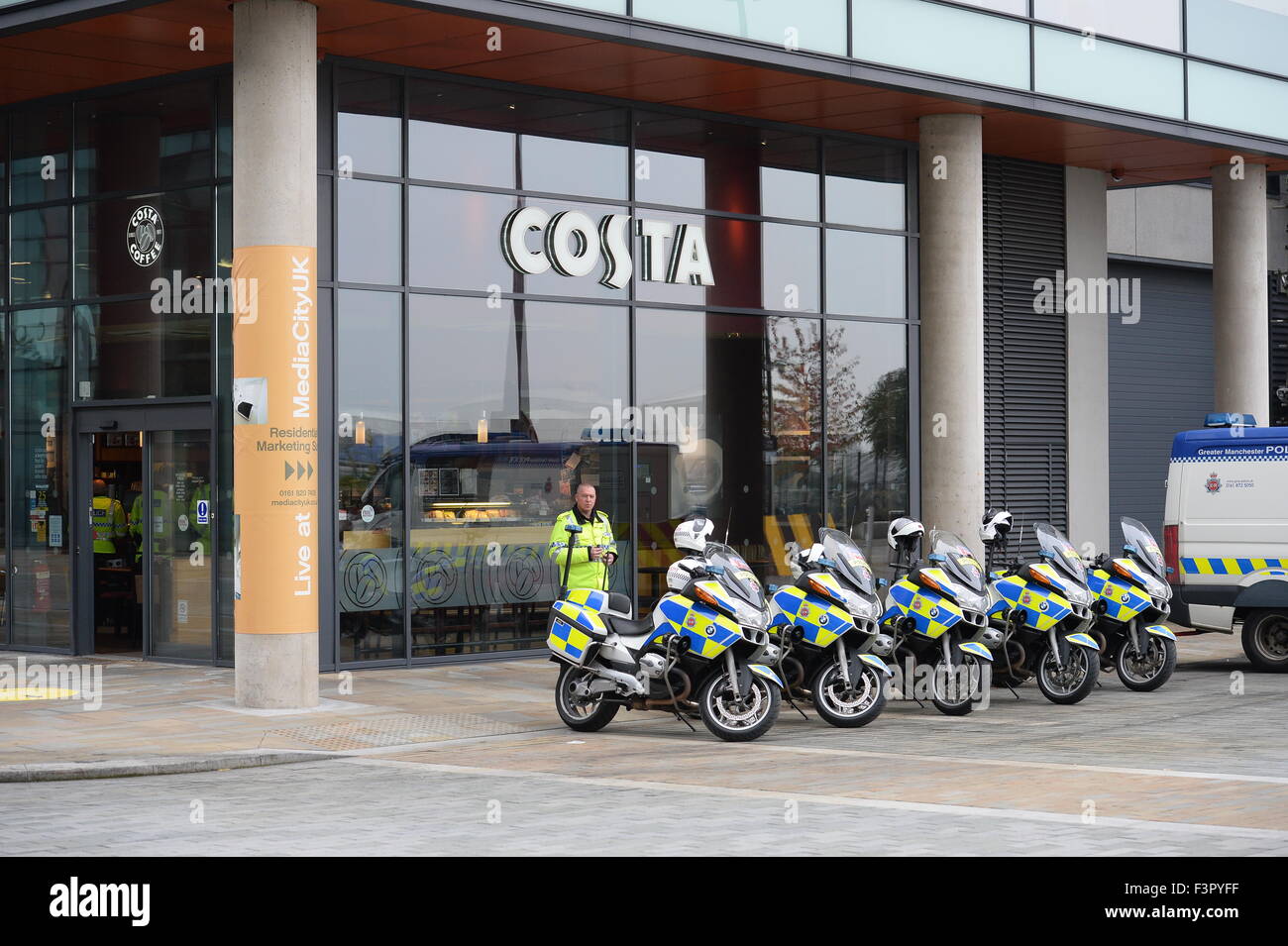 Police outriders motorbikes lined up outside Costa Coffee at Media City ...