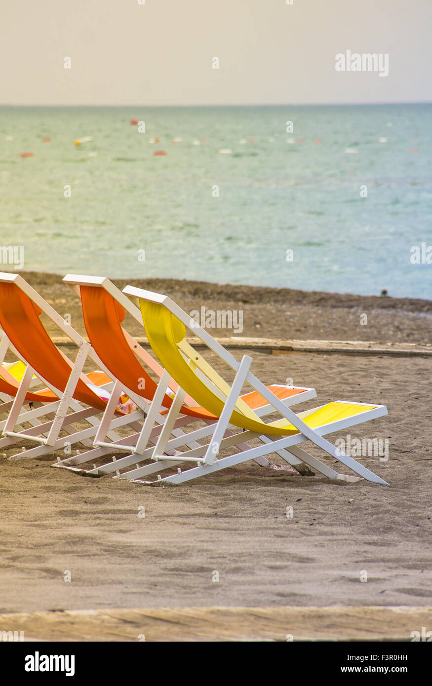 Bright colors sun chairs on the sand beach of Mediterranean sea Stock ...