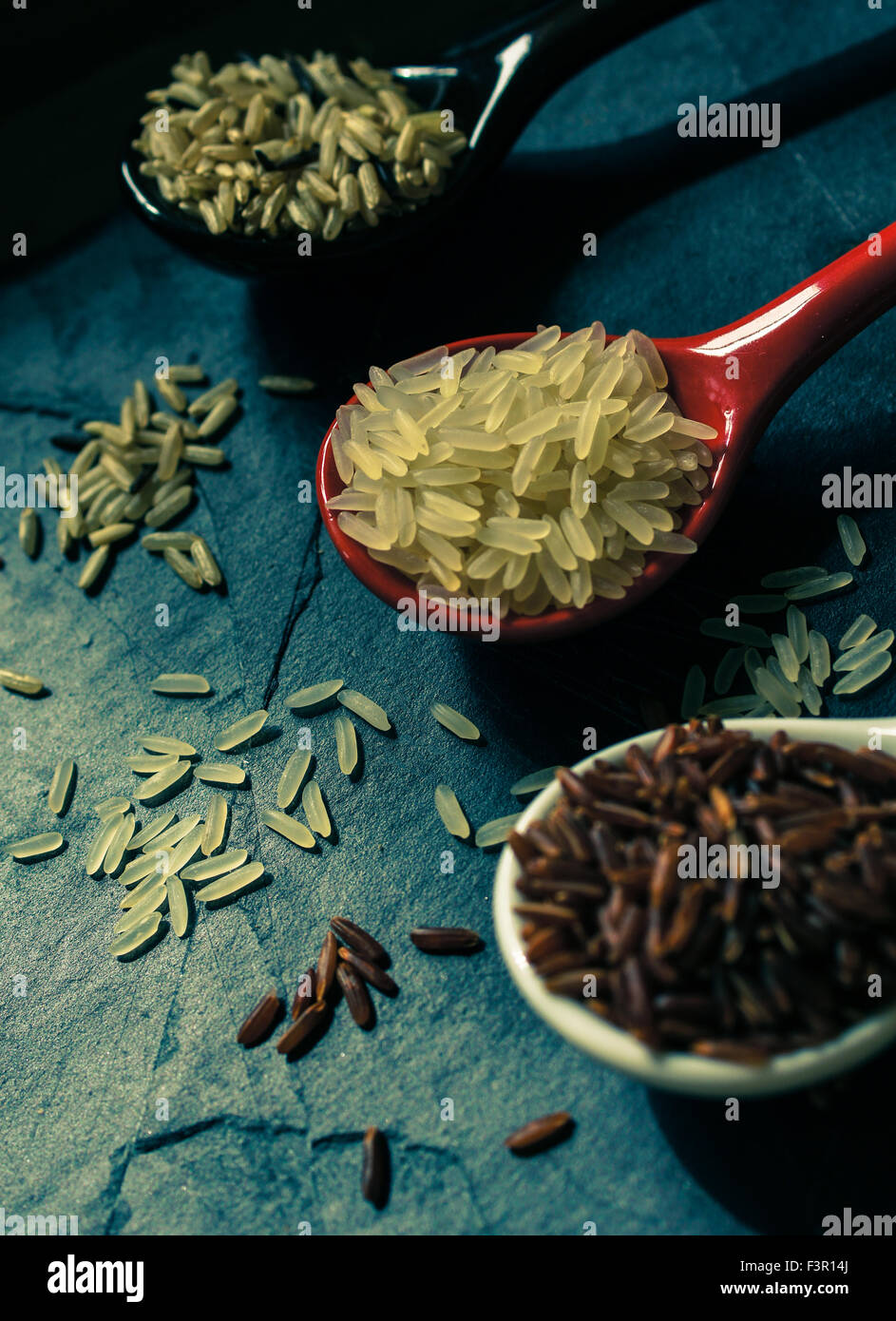 Different kinds of rice in the pots on the rustic table Stock Photo - Alamy