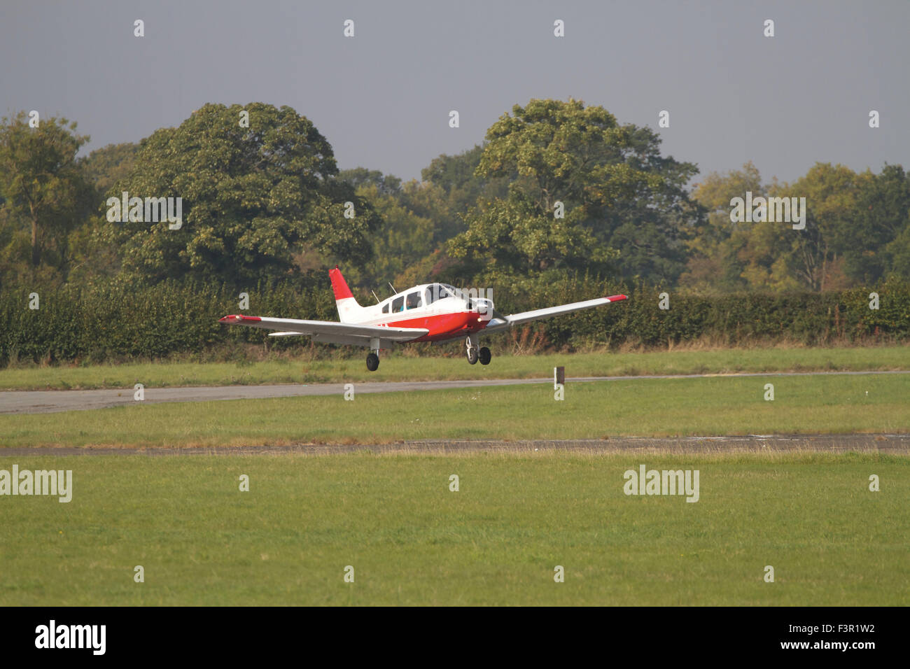 Single engined light aircraft taking off along runway. Wolverhampton ...