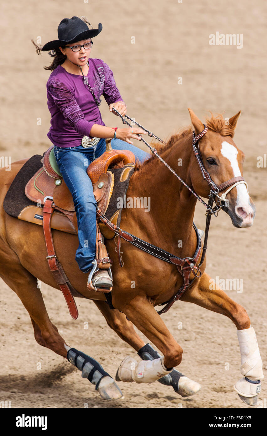 Rodeo cowgirl on horseback competing in barrel racing event, Chaffee ...