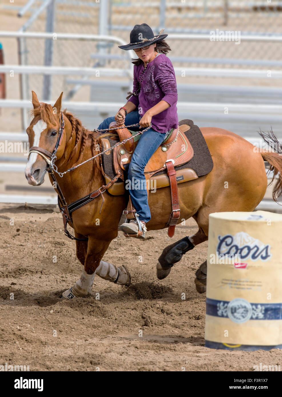 Rodeo cowgirl on horseback competing in barrel racing event, Chaffee ...