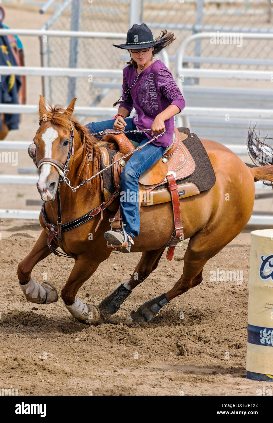 Rodeo cowgirl on horseback competing in barrel racing event, Chaffee ...