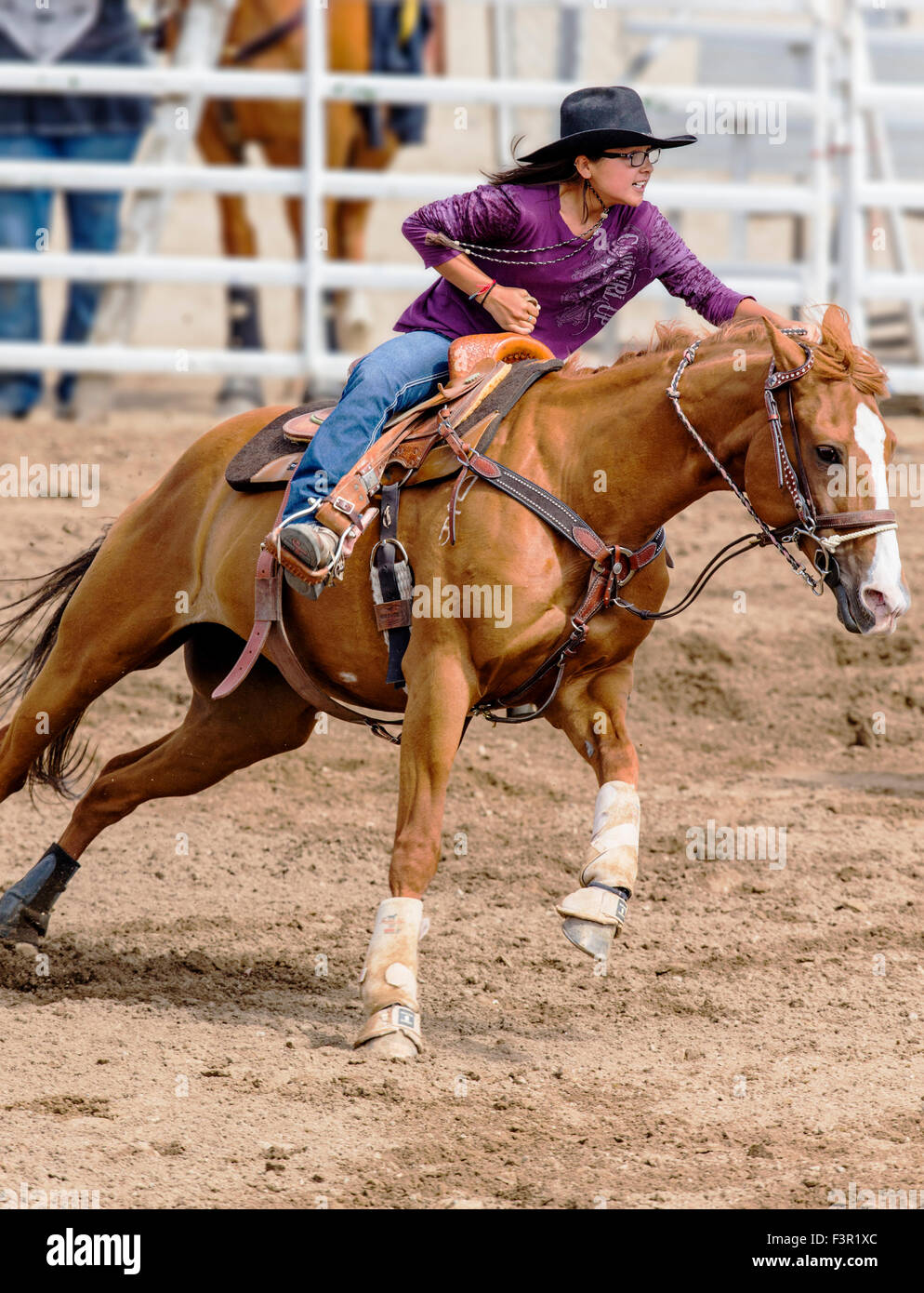 Rodeo cowgirl on horseback competing in barrel racing event, Chaffee ...